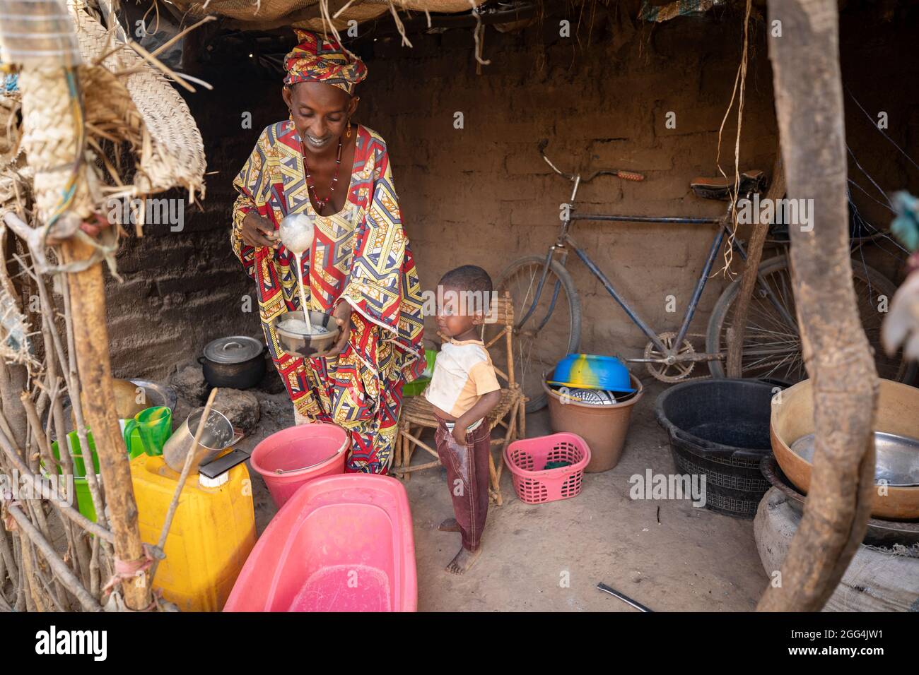 A woman serves her children breakfast porridge in from their home in ...