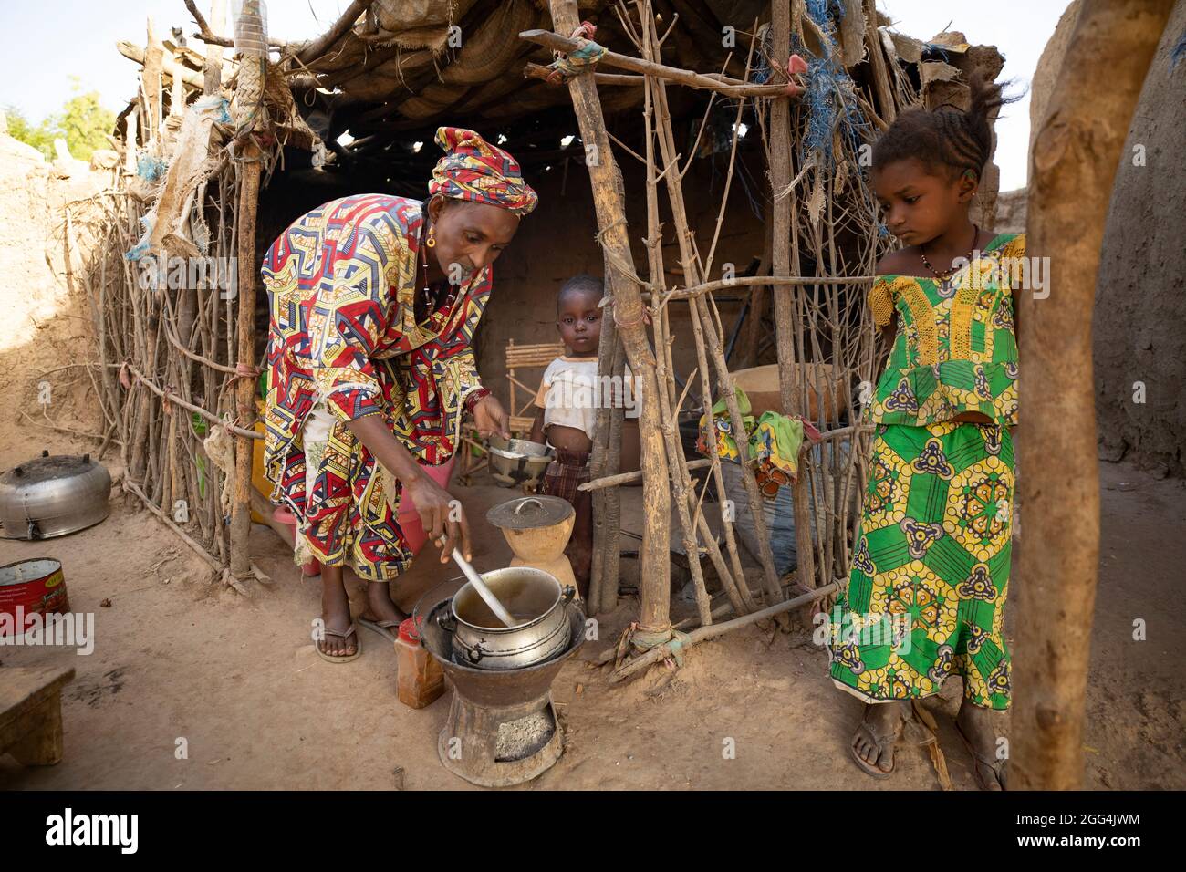 A woman serves her children breakfast porridge in from their home in ...