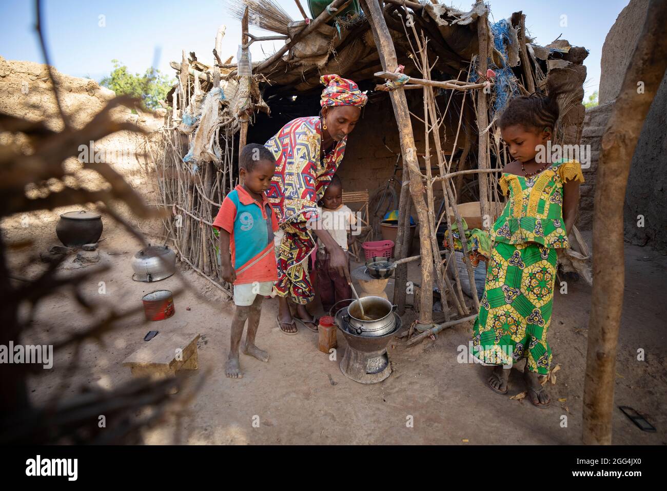 A woman serves her children breakfast porridge in from their home in ...