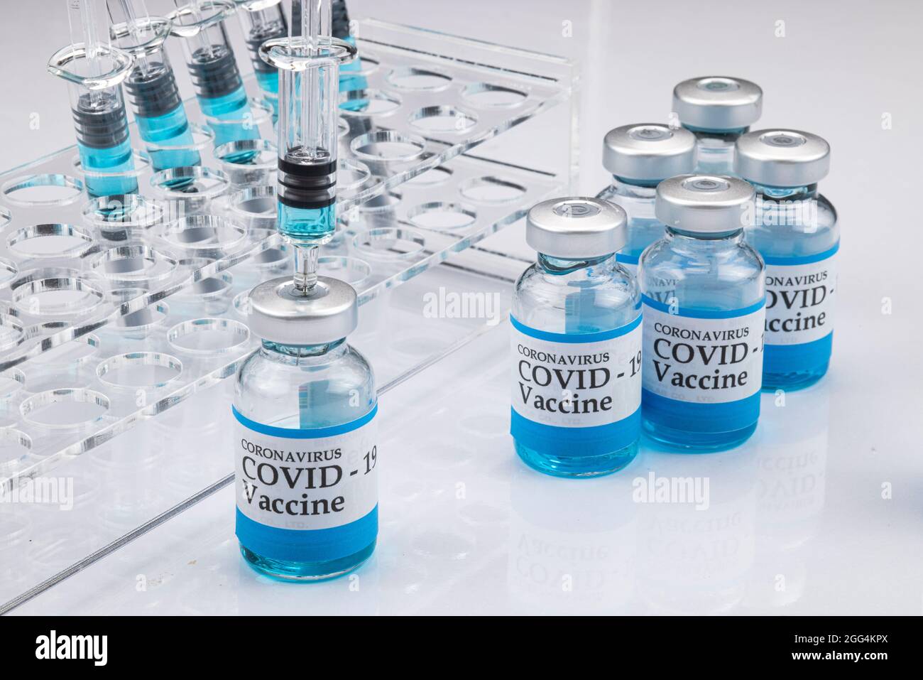 Glass vials labelled with COVID-19 text on white background. Covid-19 ...