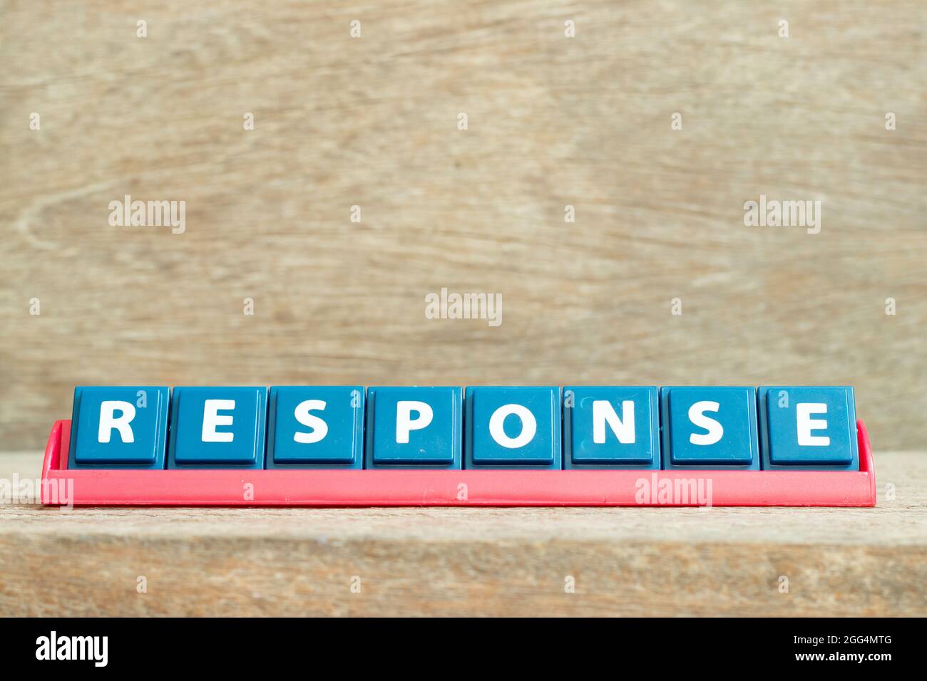 Tile alphabet letter with word response in red color rack on wood ...