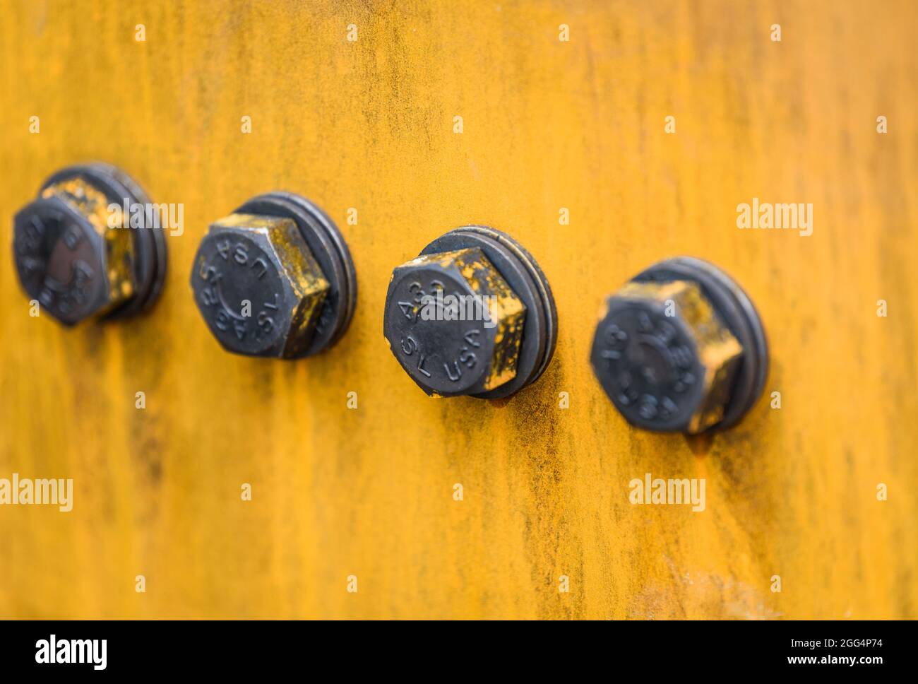 Surface rust surrounds nuts and flat washers on a new steel footbridge ...