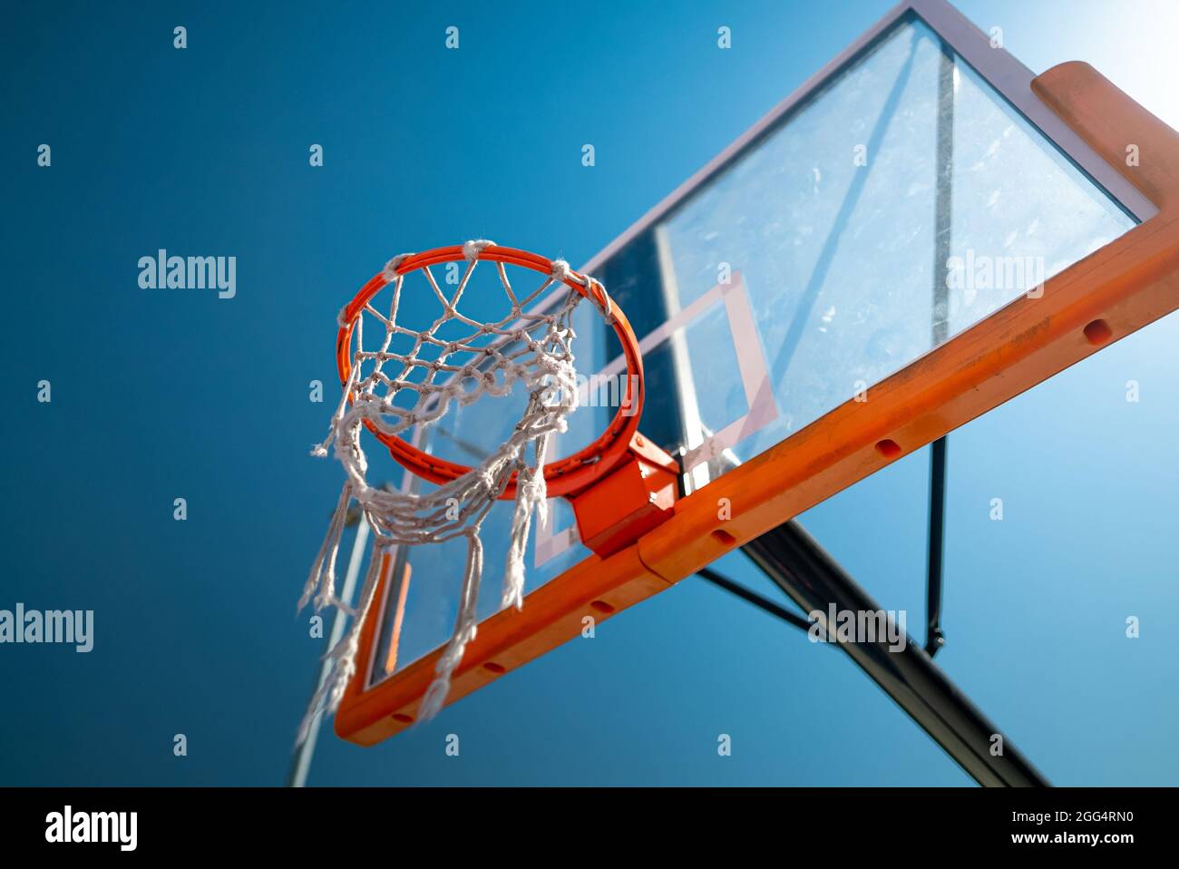 Basketball hoop close up outdoors with old net. Blue sky on background ...
