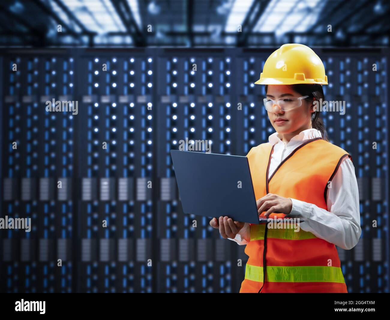 Programmer or engineer with computer notebook in server room Stock Photo - Alamy