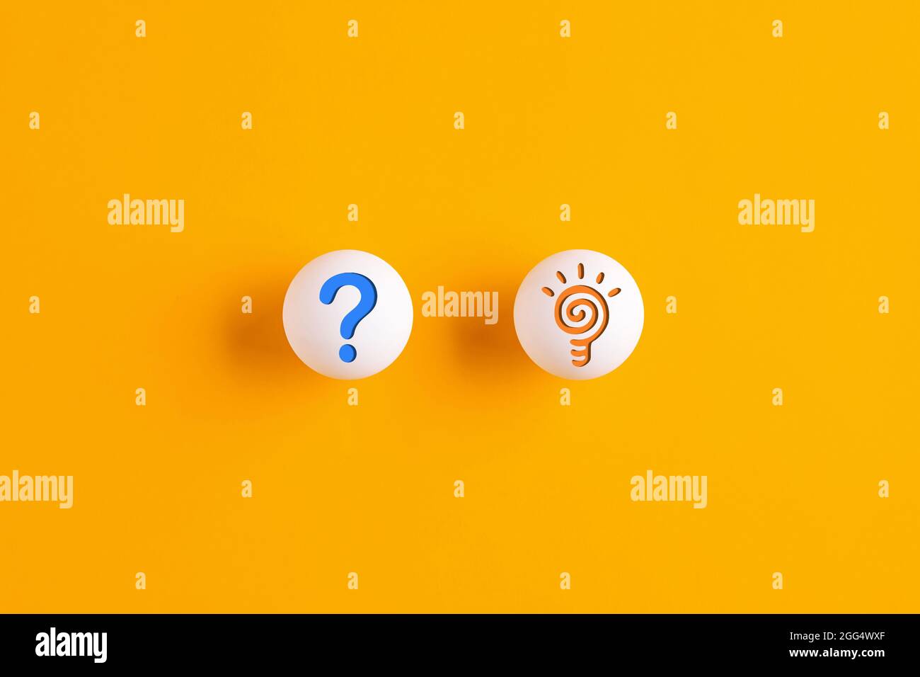Question mark and light bulb idea icons on table tennis balls on yellow ...