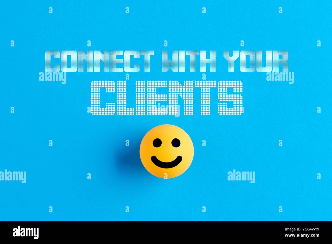 Smiling face icon on a ball with the message connect with your clients ...