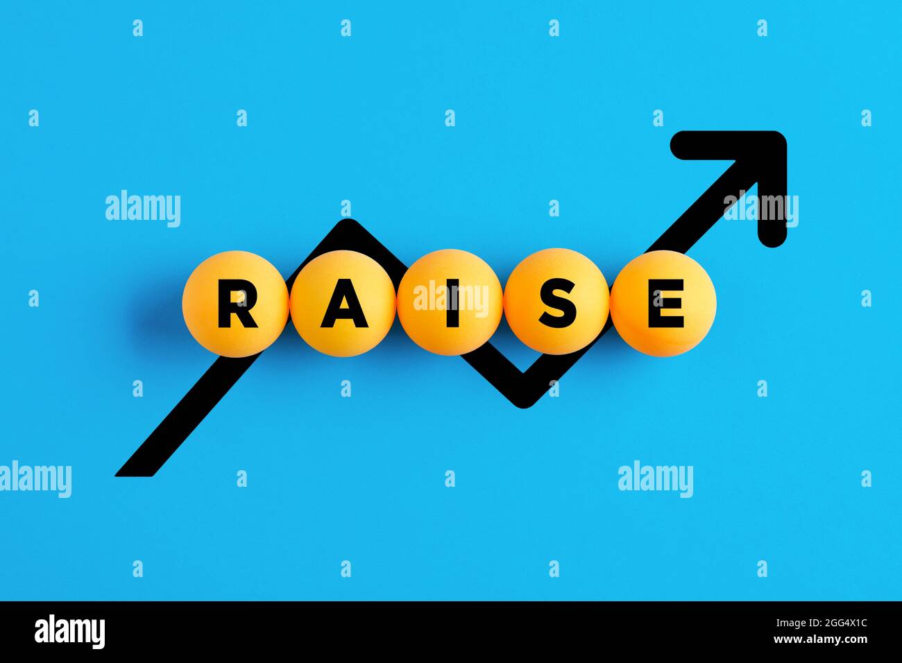 The word raise written on yellow balls with increasing line chart on ...
