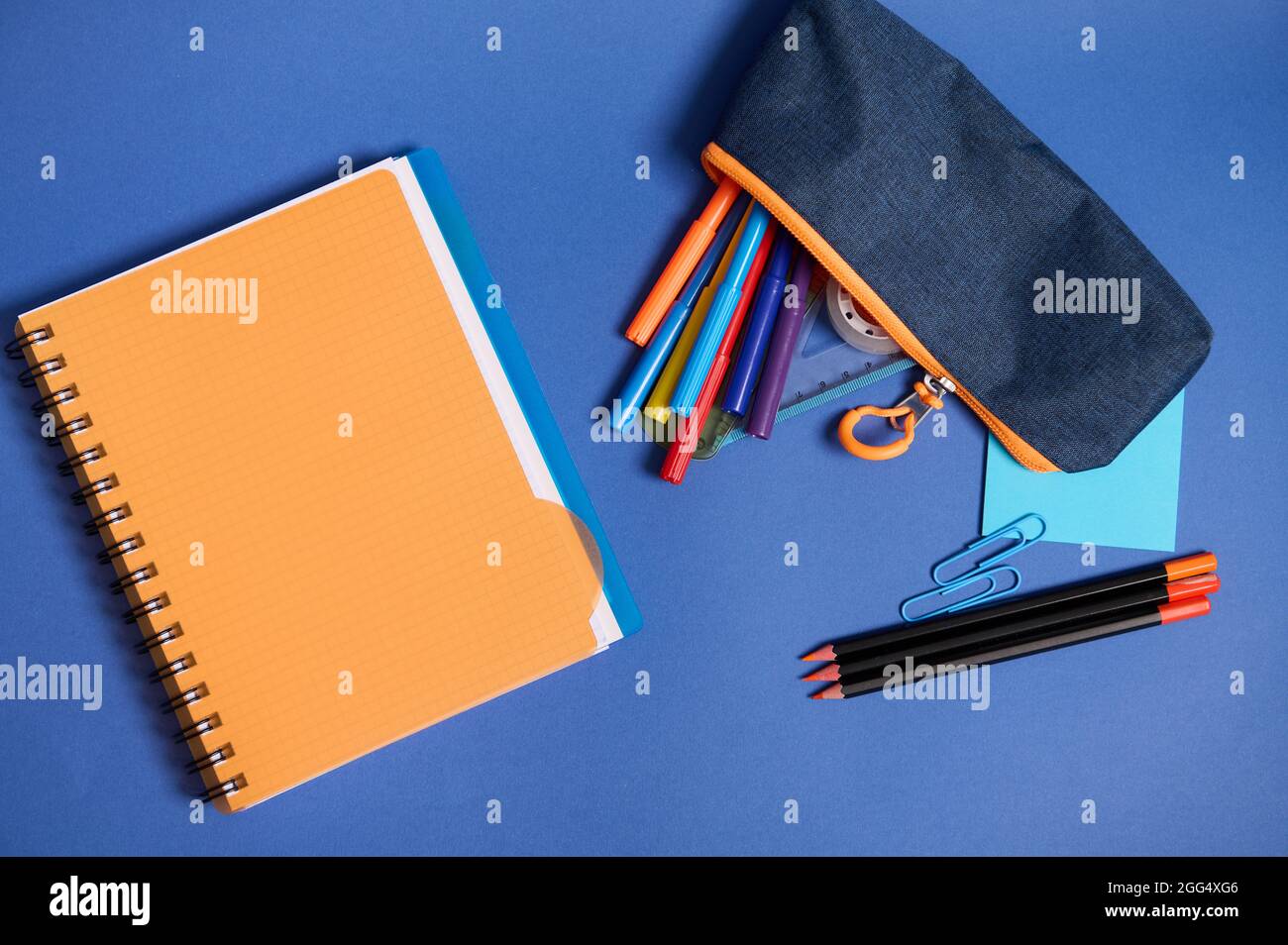 Flat lay with copybook, organizer, colorful pencils and pencil case ...