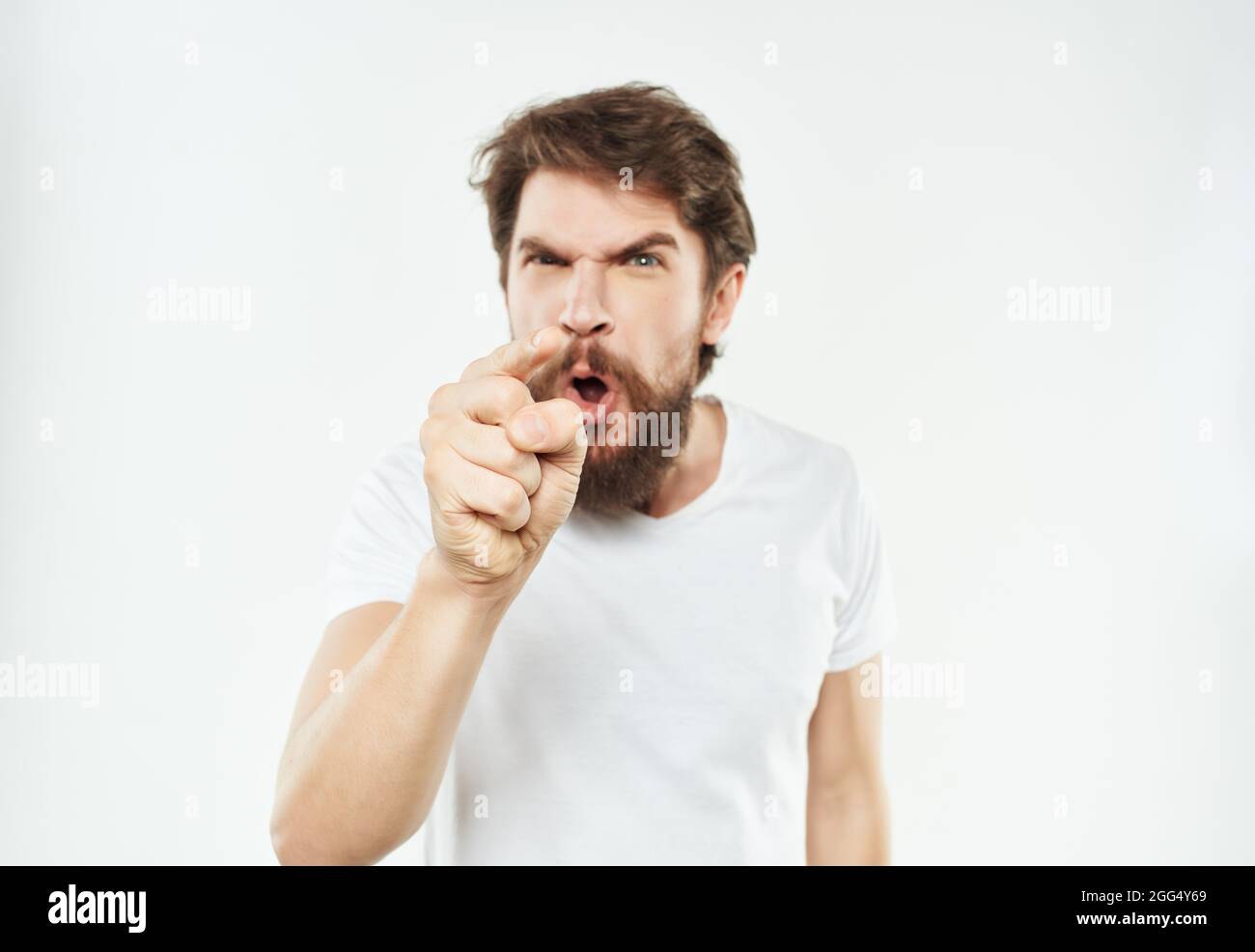 Man in a white t-shirt hand gestures anger close-up Stock Photo - Alamy