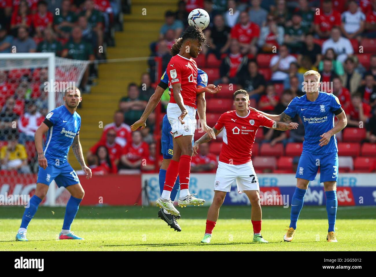 Romal Palmer #21 of Barnsley jumps up to win the high ball Stock Photo ...