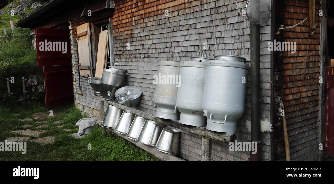 old empty milk cans at an alpine hut in Switzerland Stock Photo - Alamy