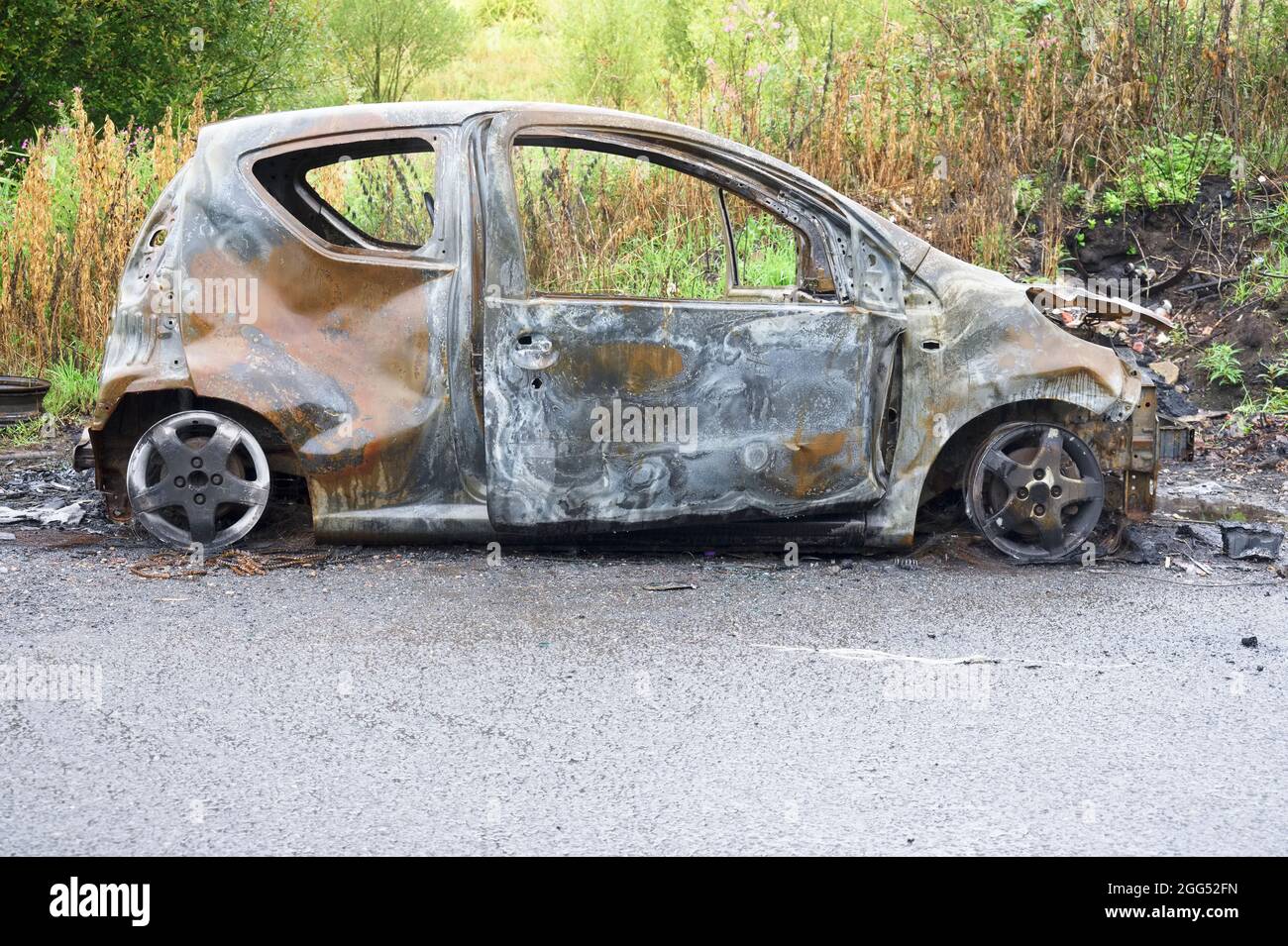 Burnt out car set of fire and left by joy rider Stock Photo - Alamy