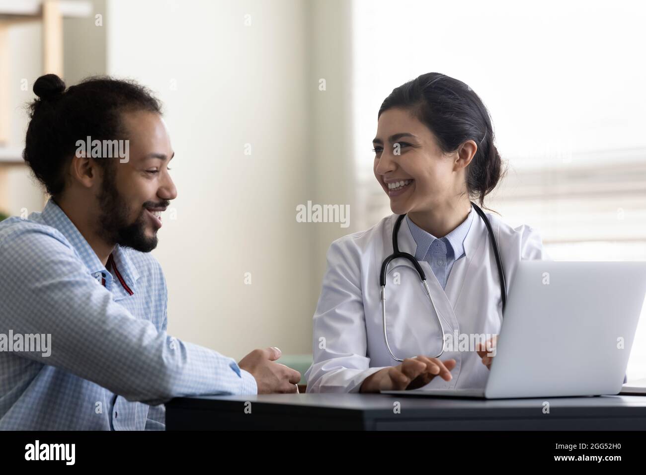 Happy millennial african american patient talking with indian doctor ...