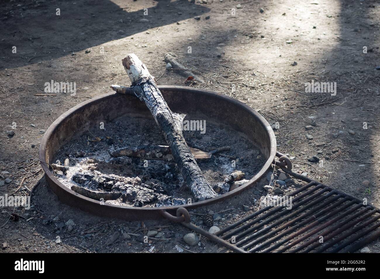 charcoaled piece of wood left blackened in a camp ground firepit Stock ...