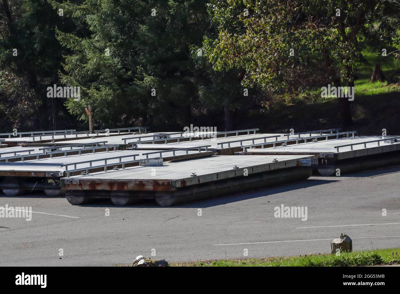 large concrete slabs of premade floating pier segments sitting in a ...