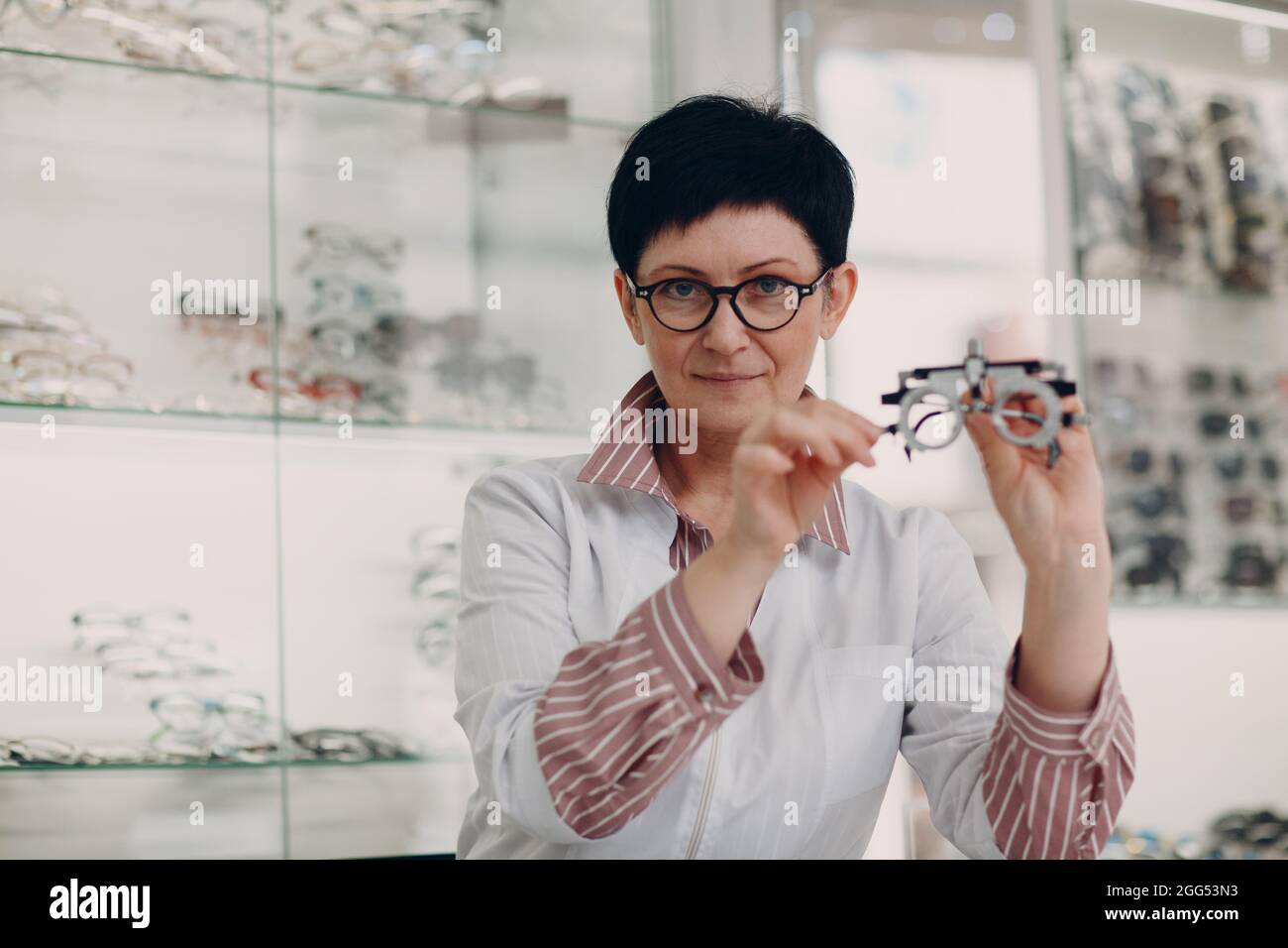 Happy Optician Choosing Eyeglasses, female optometrist with glasses ...