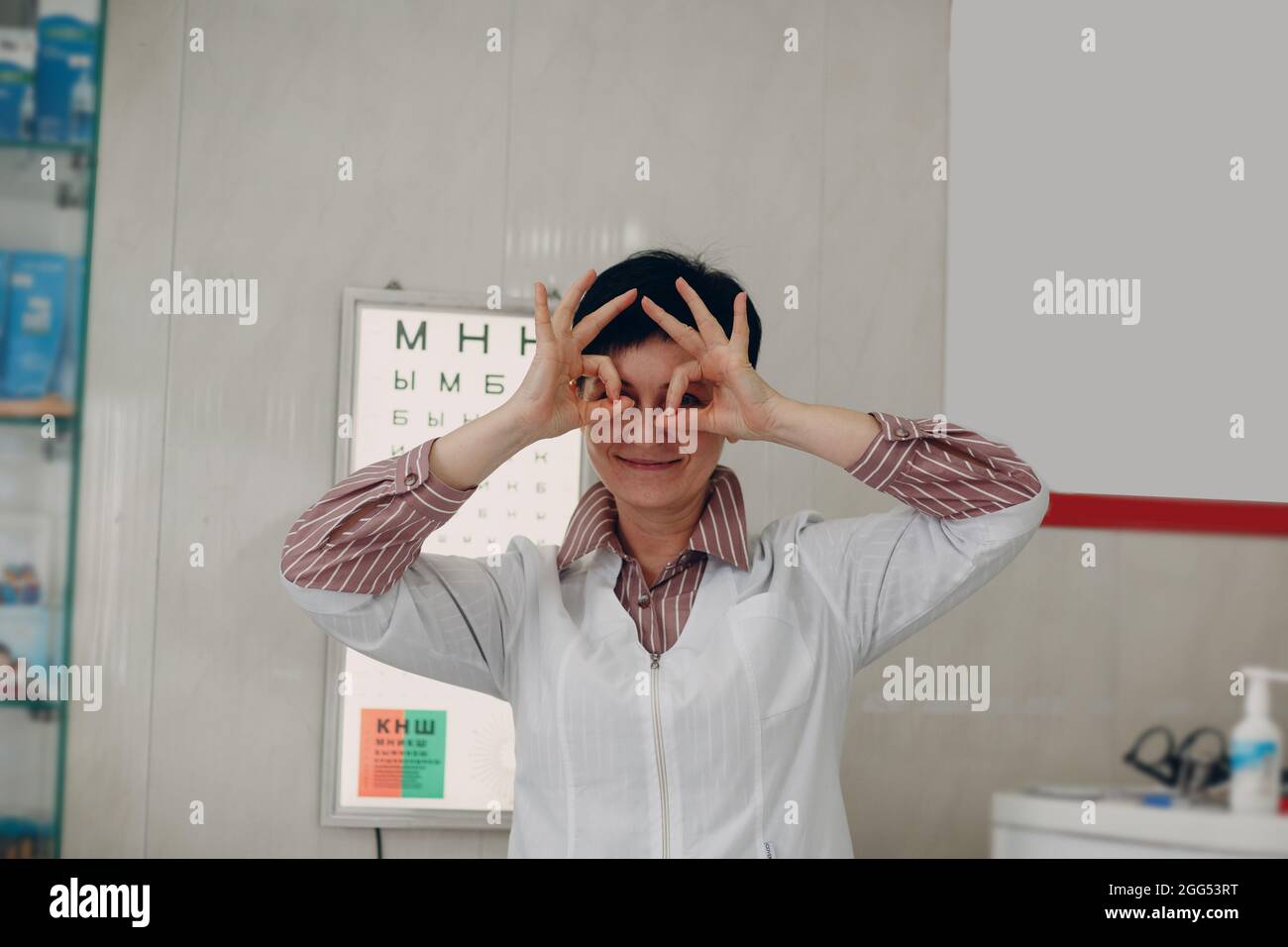 Doctor optician with letter chart for eye vision test check Stock Photo ...