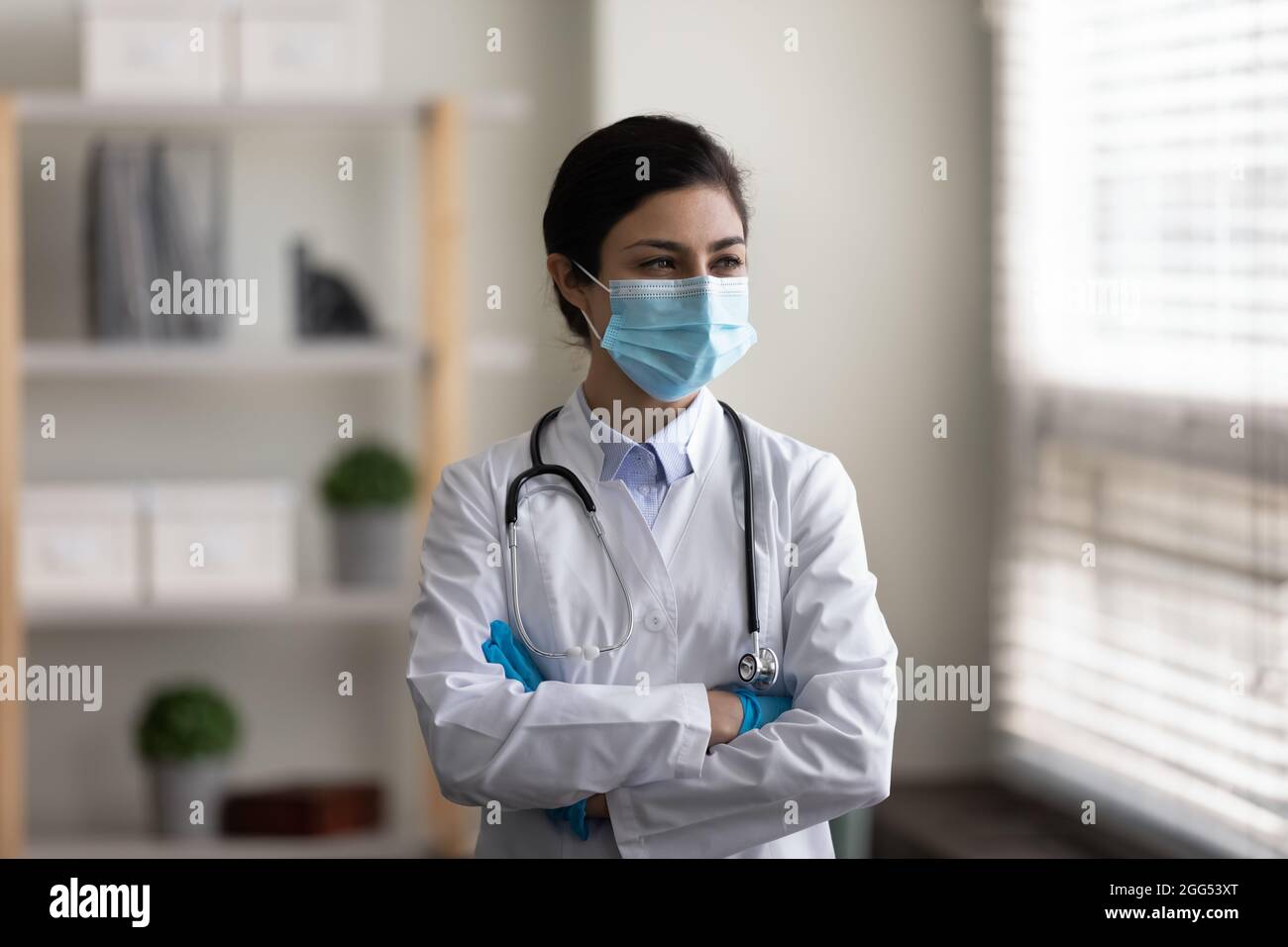 Lost in thoughts young indian doctor standing in clinic Stock Photo - Alamy
