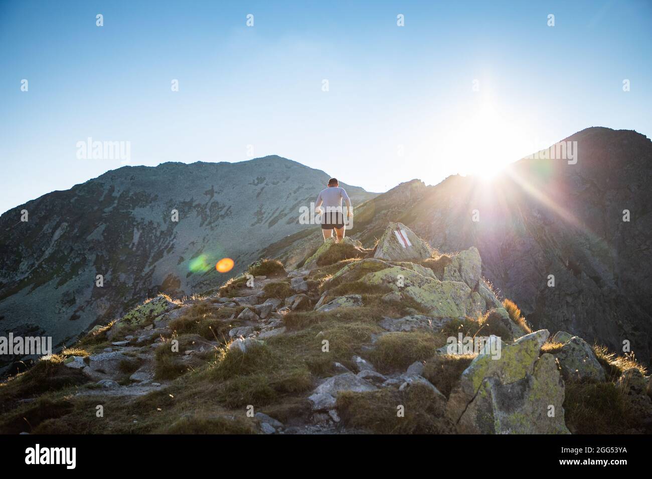 trail runner running in mountain landscape at sunset active lifestyle ...