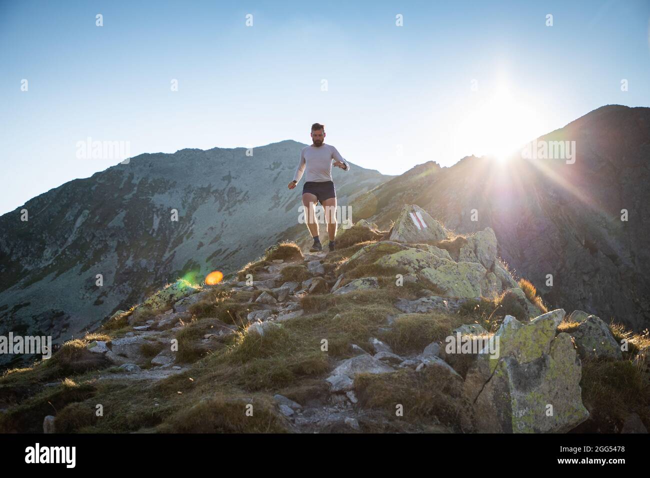 trail runner running in mountain landscape at sunset active lifestyle ...