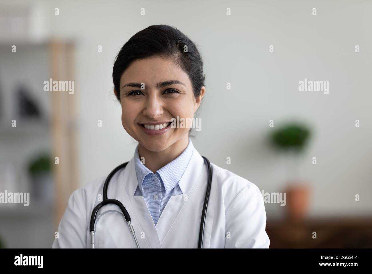 Portrait of smiling confident young indian gp doctor Stock Photo - Alamy