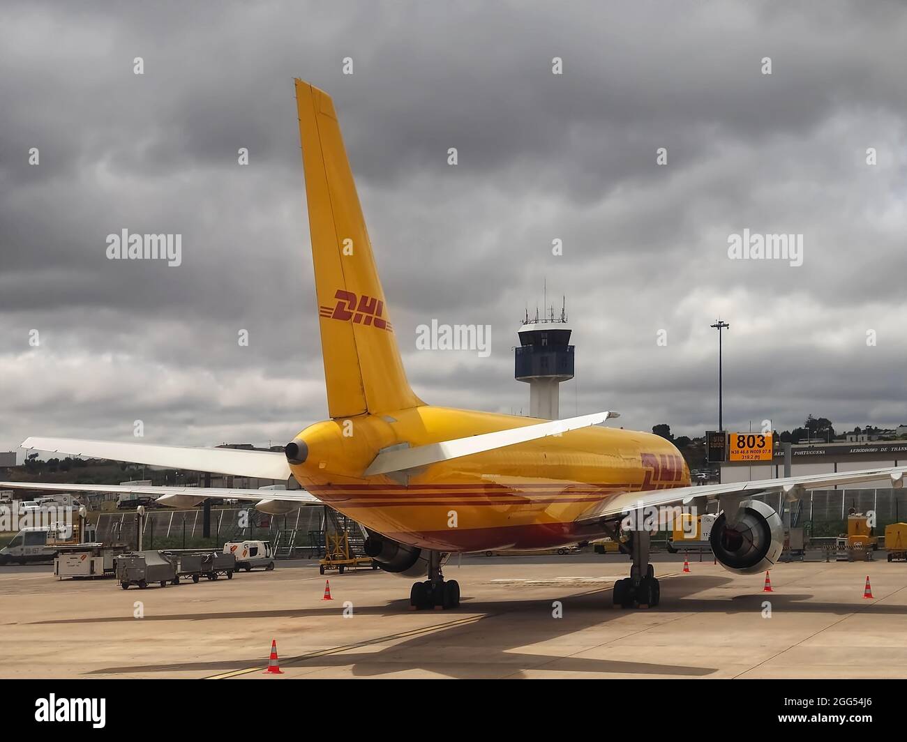 Yellow DHL plane at an airport Stock Photo - Alamy