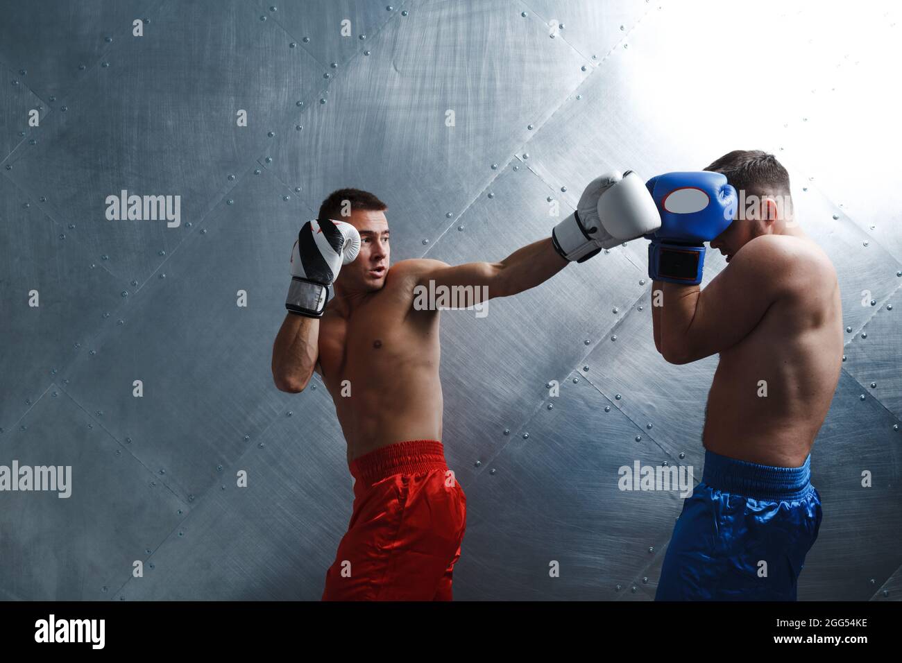 Two men boxers fighting muay thai boxing Stock Photo - Alamy