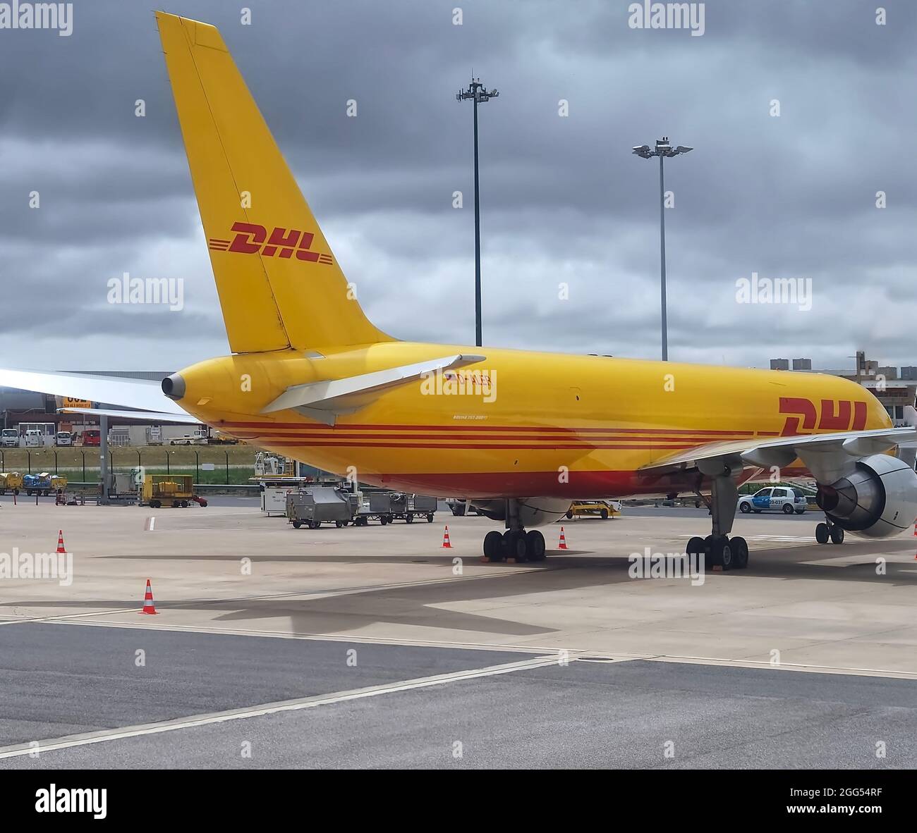 Yellow DHL plane at an airport Stock Photo - Alamy