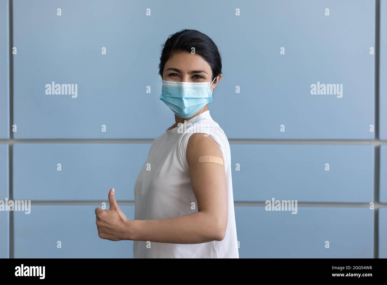 Happy young indian woman feeling good after vaccination Stock Photo - Alamy