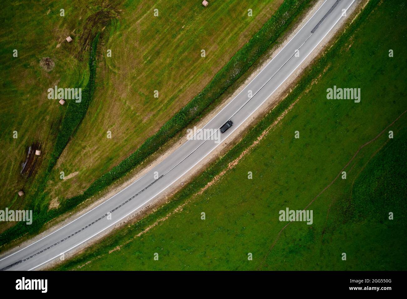 Round turn in the road aerial view. Road between fields Stock Photo - Alamy