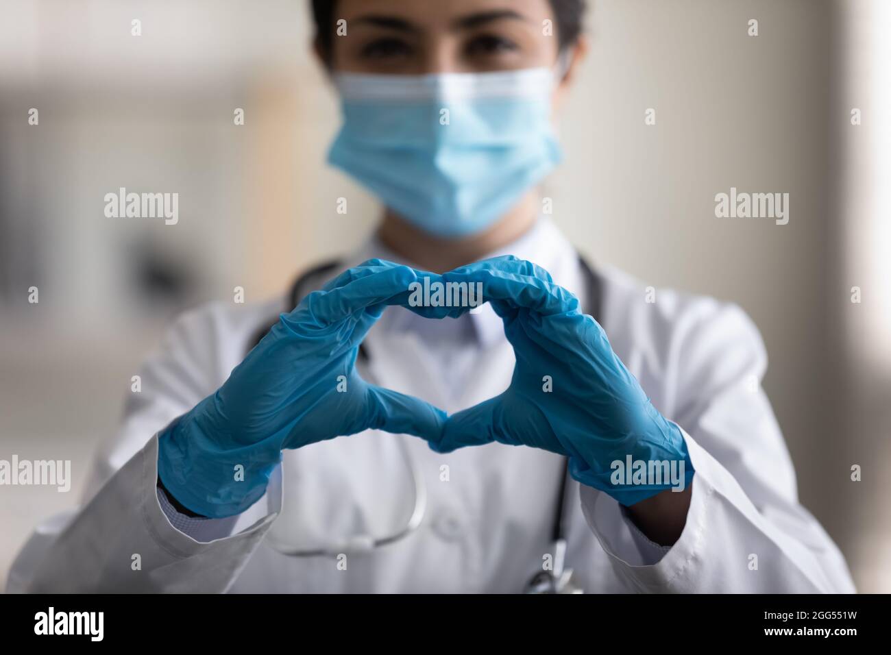 Close up millennial indian doctor showing love symbol Stock Photo - Alamy