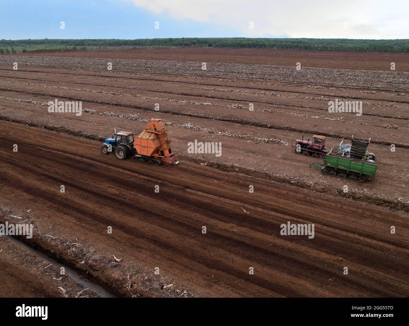 Peat extraction site. Harvester at collecting peat on peatlands. Mining ...