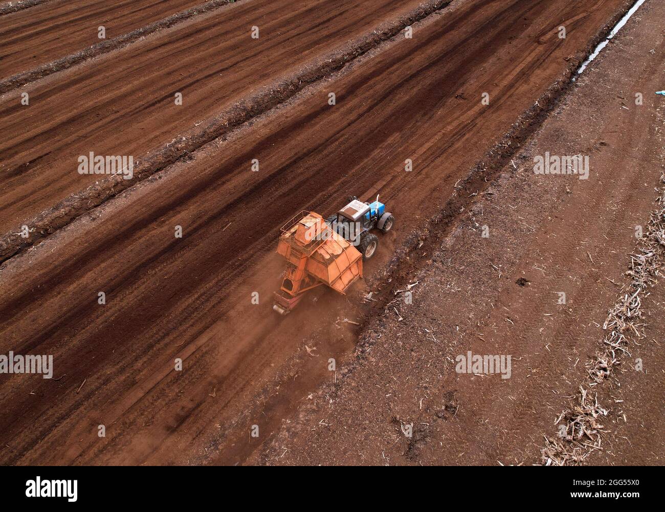 Peat extraction site. Harvester at collecting peat on peatlands. Mining ...