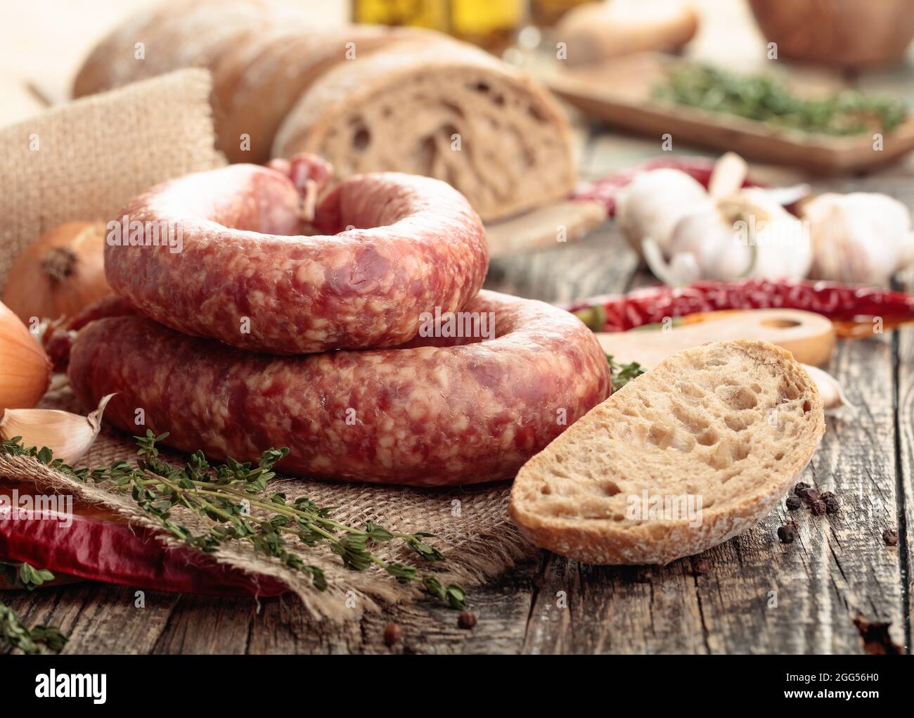 Dry-cured sausages with herbs and spices. Sausages with bread, thyme ...