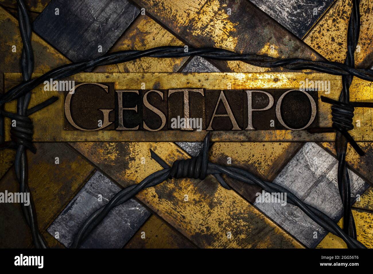 Gestapo text on grunge copper and vintage gold background with barbed ...