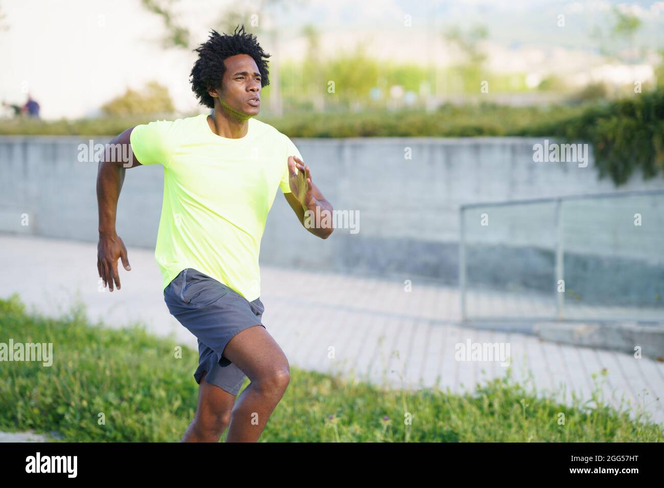 Black athletic man running in an urban park Stock Photo - Alamy