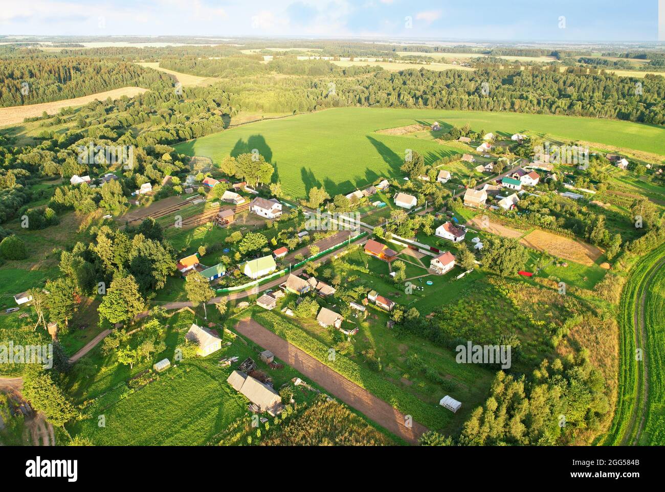 Top view of the village with wooden houses in wild among the forest and ...