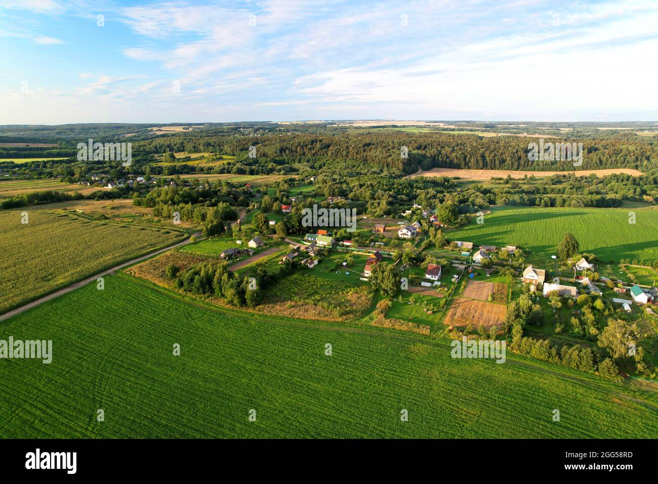 Top view of the village with wooden houses in wild among the forest and ...