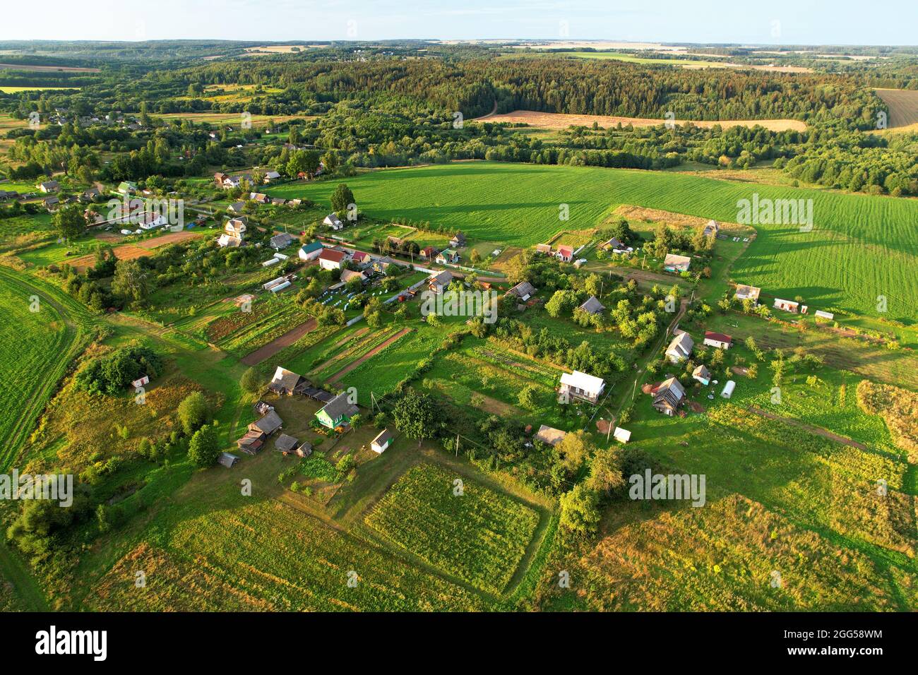 Top view of the village with wooden houses in wild among the forest and ...