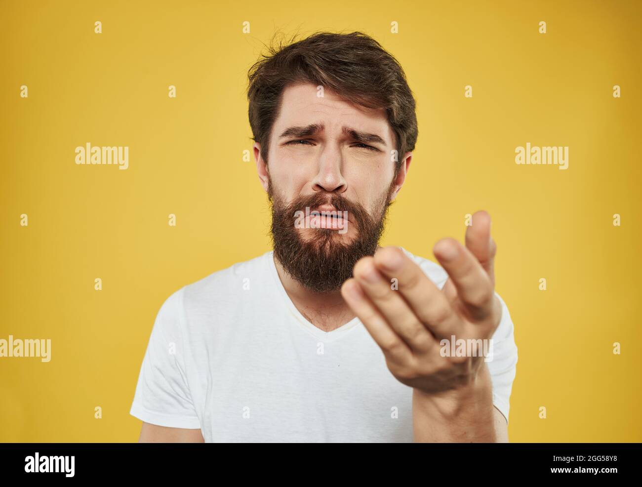 bearded man in a white t-shirt hand gestures anger Lifestyle Stock ...