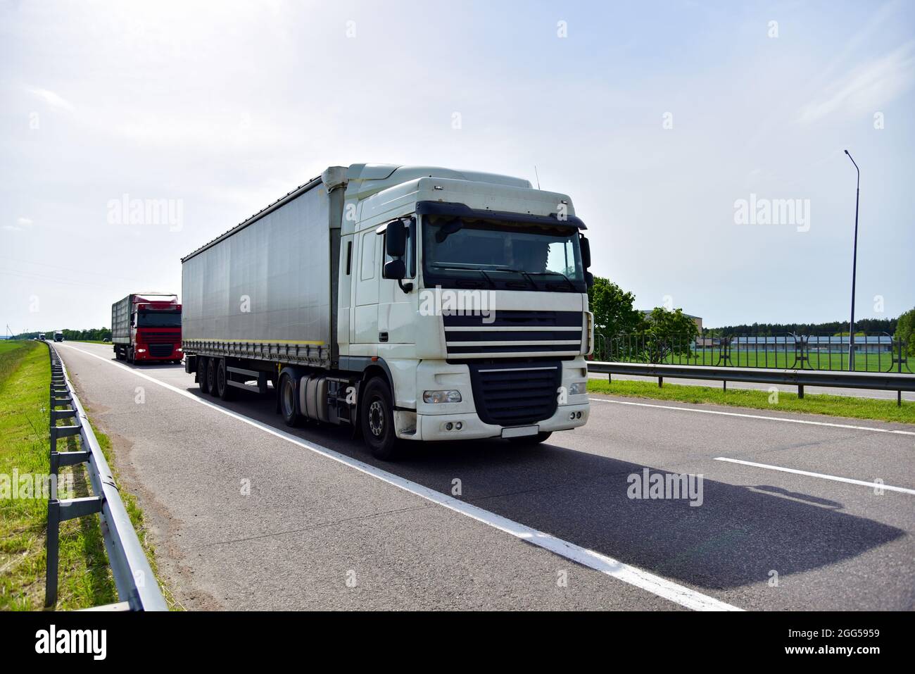 Truck with Semi-trailer driving along highway. Goods Delivery by roads ...
