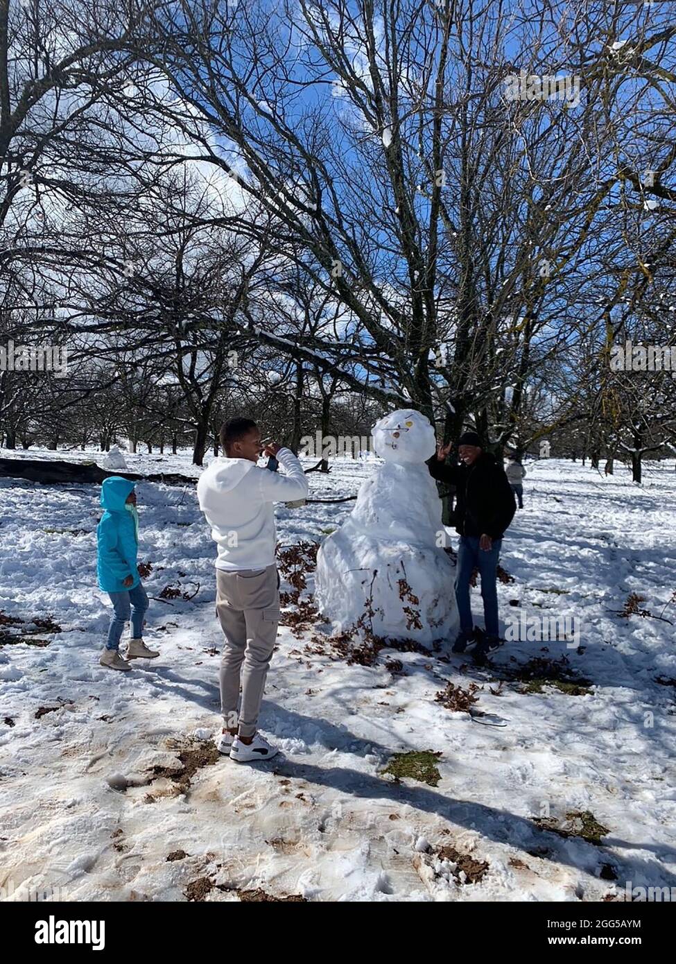 Ceres, South Africa. 29th Aug, 2021. A family enjoys the snowman they ...