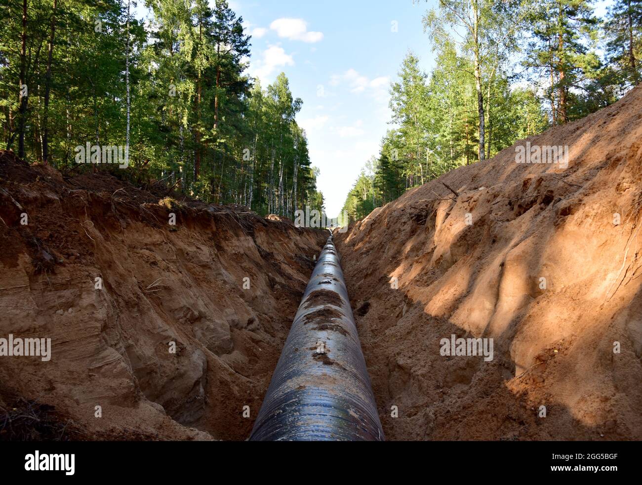 Natural Gas Pipeline Construction. Laying oil pipe in a trench in the ...