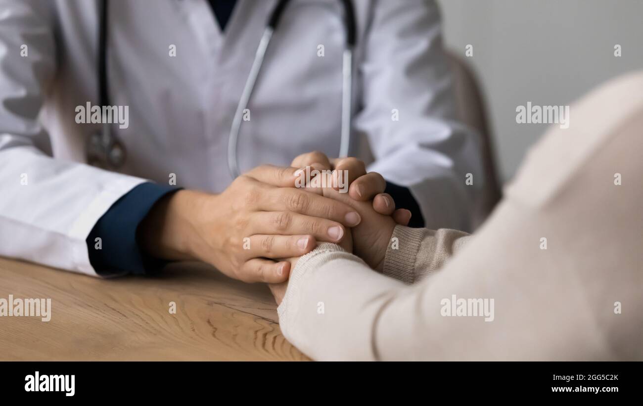 Close up young doctor supporting old patient Stock Photo - Alamy