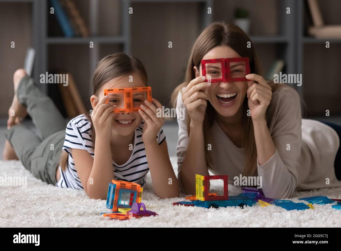 Happy two generations family having fun, playing toys Stock Photo - Alamy