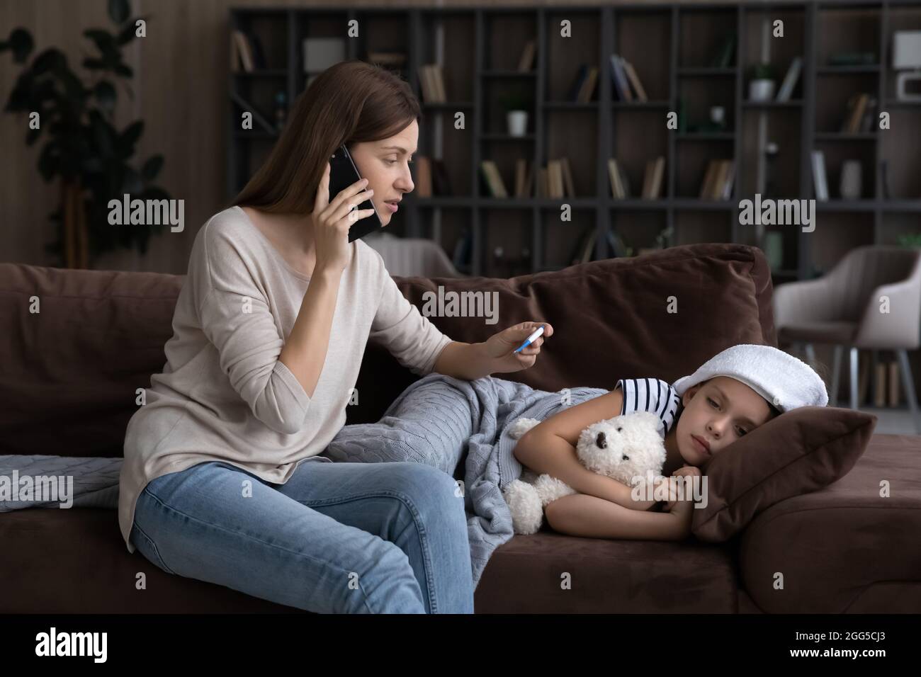 Nervous millennial mum consulting by phone call with pediatrician Stock ...