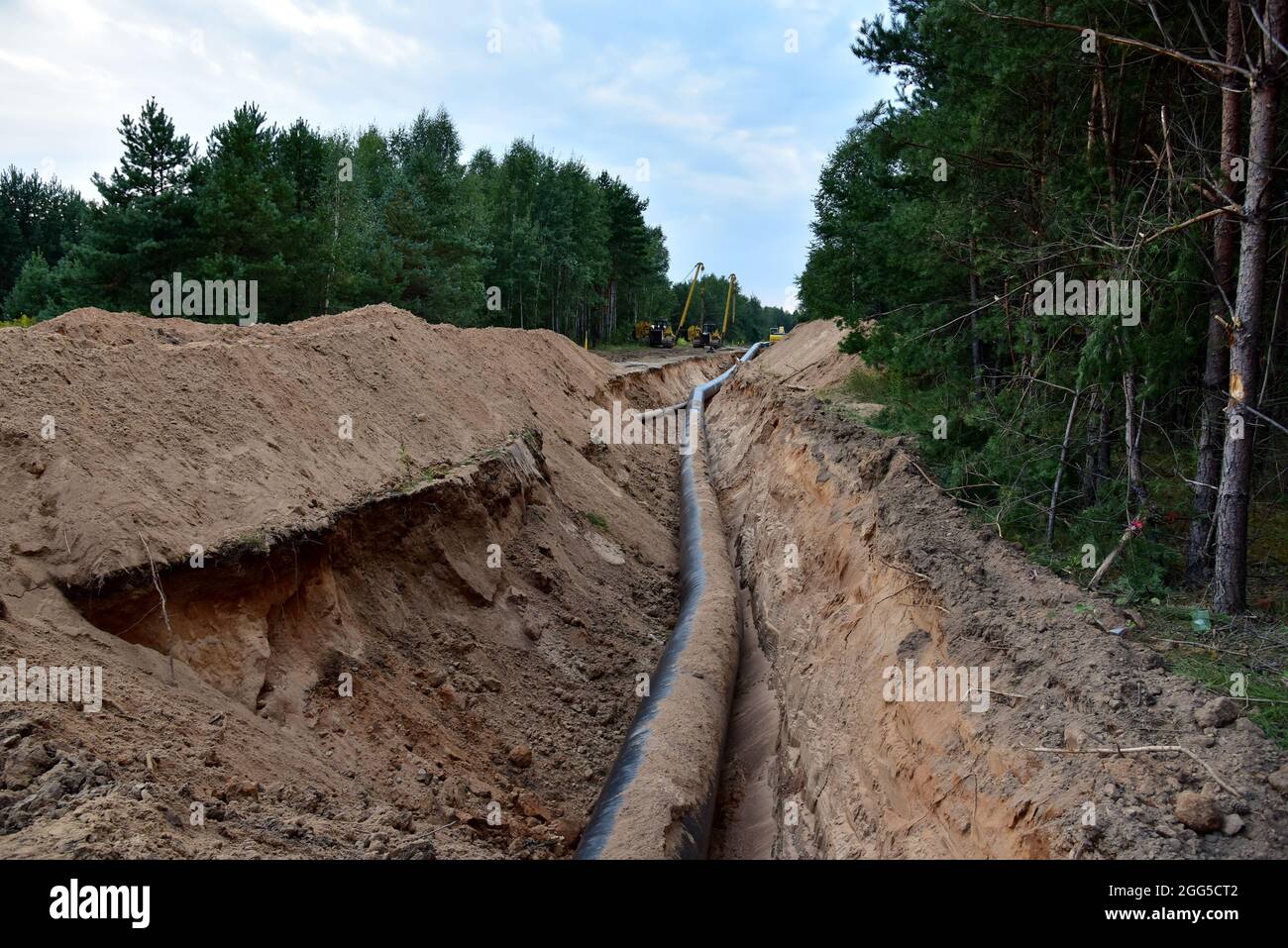 Natural Gas Pipeline Construction. Laying oil pipe in a trench in the ...