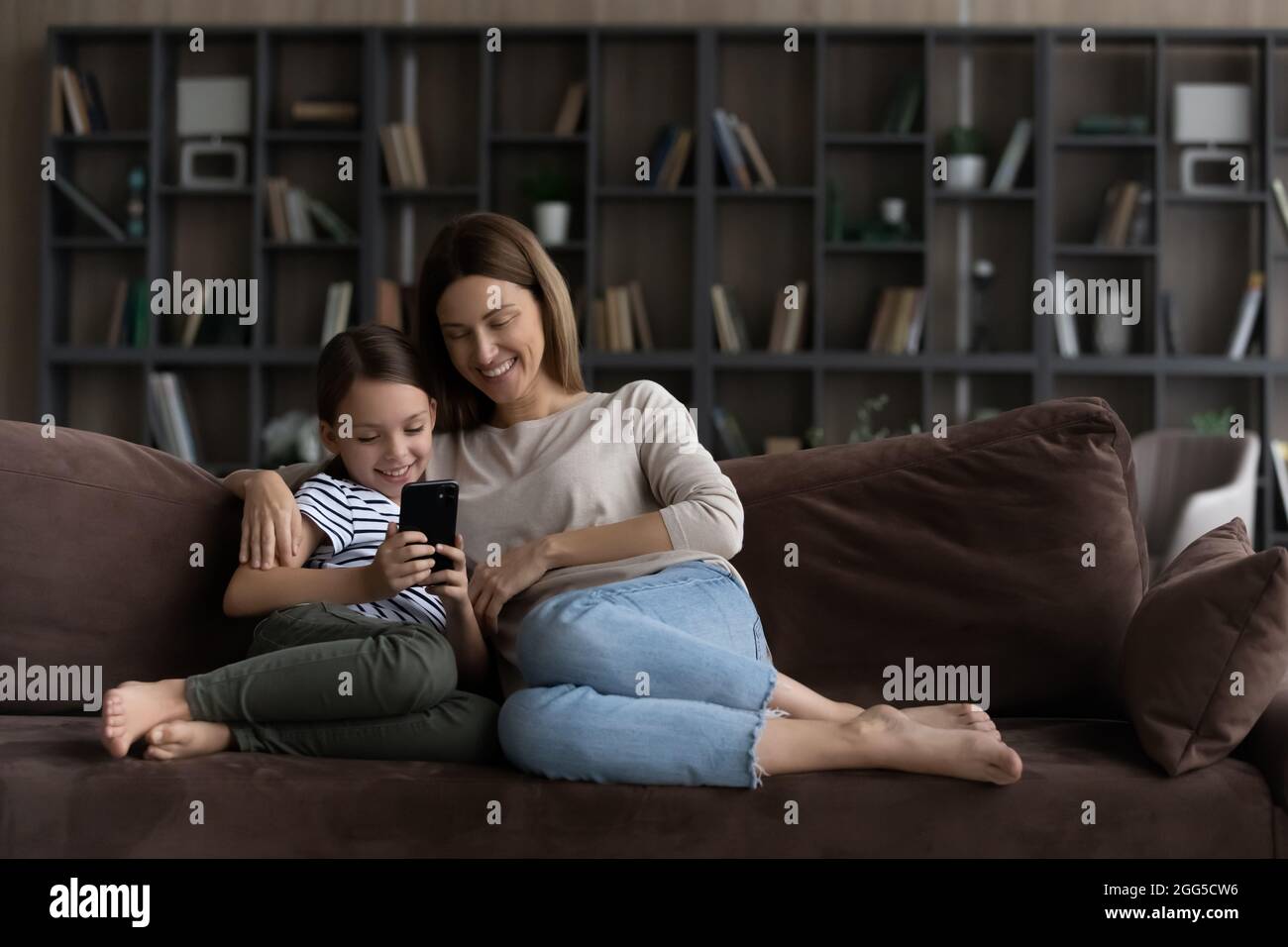 Happy two generations family using smartphone applications Stock Photo ...