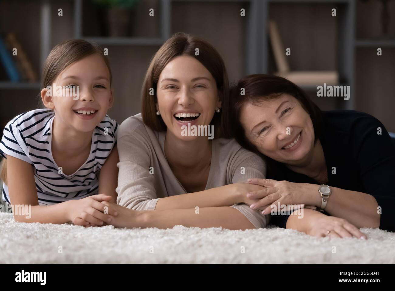 Happy three generations family having fun indoors Stock Photo - Alamy