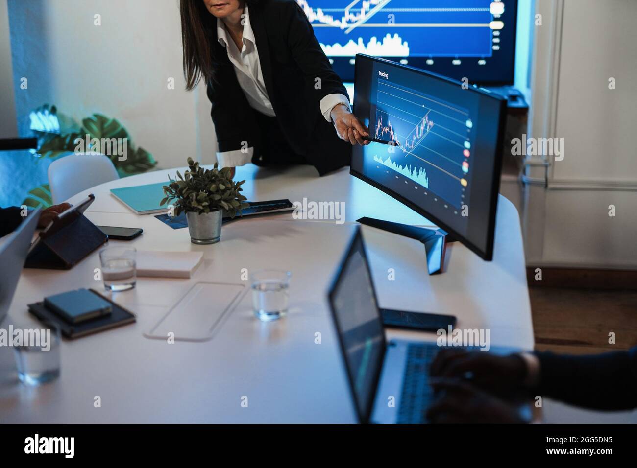 Business woman explaining trading strategies inside bank meeting room ...